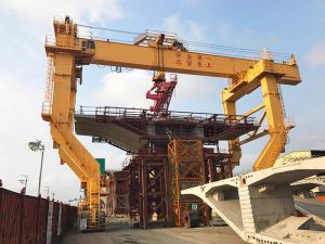 The Role of Straddle Carriers in Lifting Precast Segmental Bridges